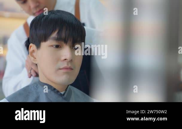A Professional Barber Asian Man Uses Scissors And Combs To Trim Hairs