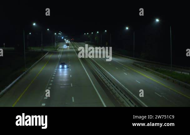 Night suburban highway with cars that rise from the Black Sea coast ...
