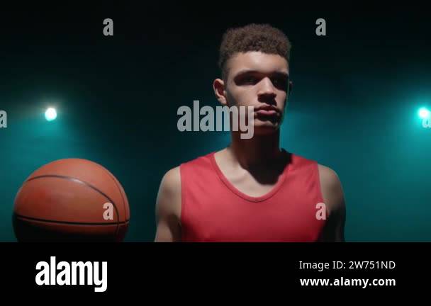 Portrait of young guy basketball player with a ball in hand. An athlete ...