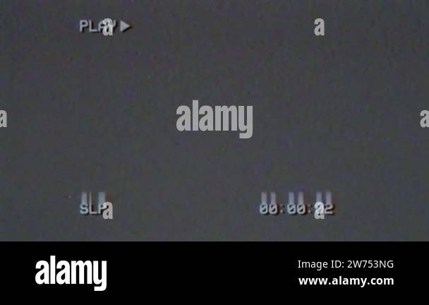 VHS. Old gray screen with PLAY text and timecode. An old bad VHS tape ...