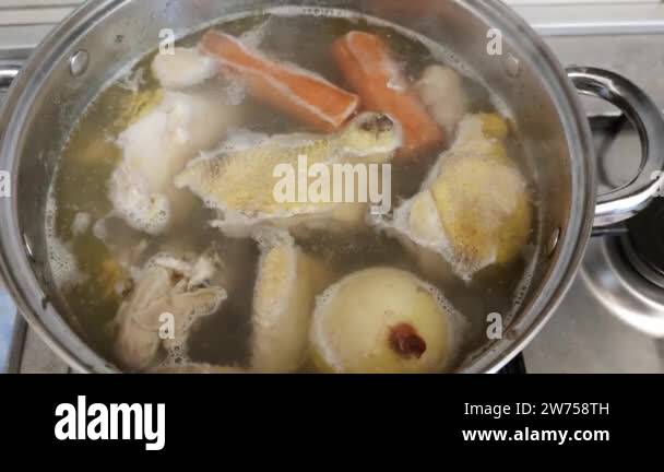 Cooking in boiling water fatty chicken broth from meat and bones with ...
