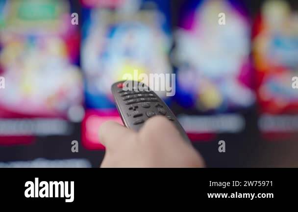 girl controls the TV remote control in room at home, rest on weekend ...