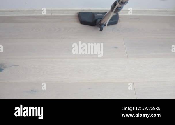 Vacuuming the light oak floor with water. Wet cleaning of the house ...