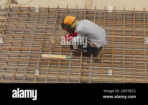 Metal Frame Construction. A welder welds a metal structure. Welding ...