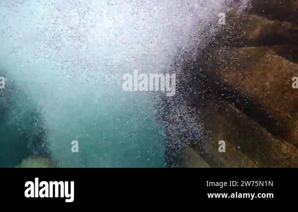 Water churned boils and bubbles underwater of fast flowing waters of ...