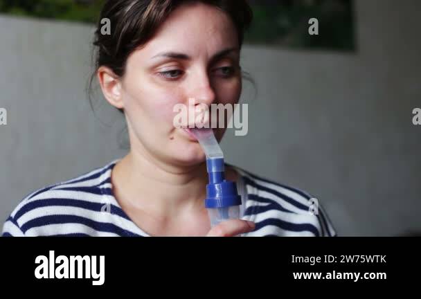 Woman wears a mask for inhalation, and conducts the procedure lungs ...