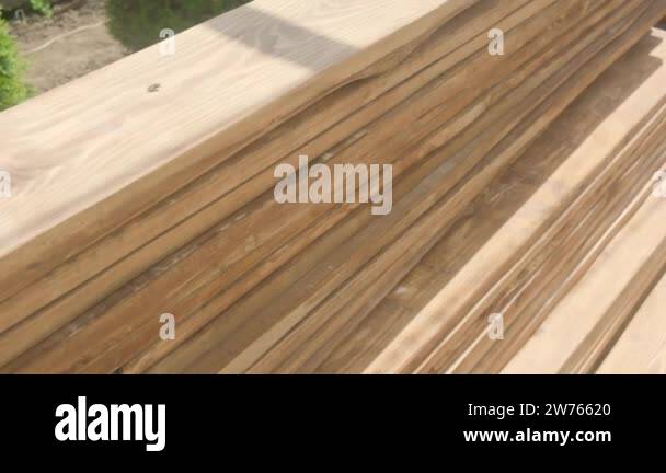 Piles of wooden planks at a sawmill, formwork. Warehouse for sawing ...