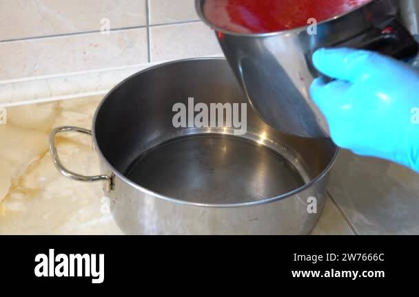 Pouring mashed European Cornel for jam into pot (Cornus mas Stock Video ...