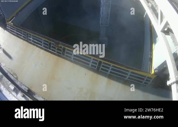 preparation of the ships hold for loading grain. laying of hoses for ...