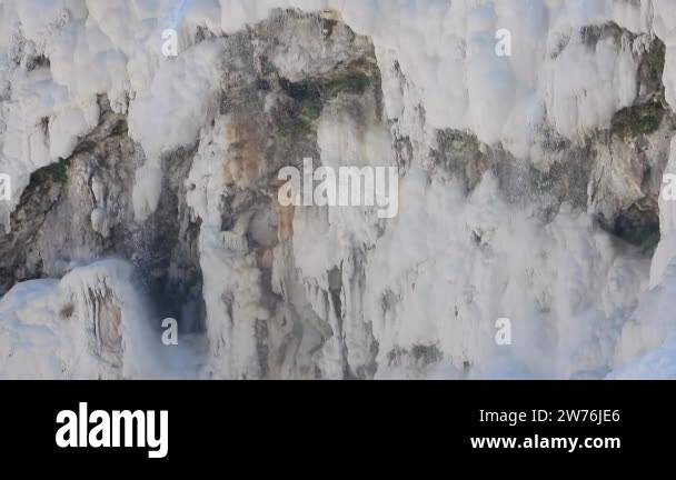 White travertine rock formed with the calcium carbonate mineral in the ...