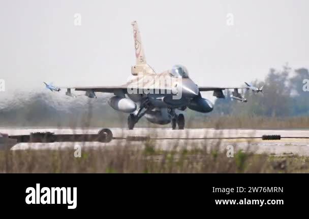 Frontal close view follow 4k video of a military fighter jet take off ...