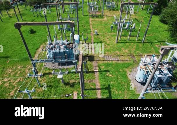 Transformers, utility towers, and power lines cover the grounds of an ...