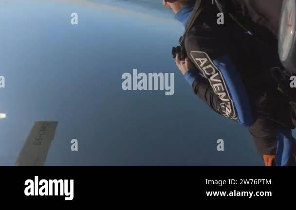 Footage of two skydiver falling the free fall and their parachute opens ...