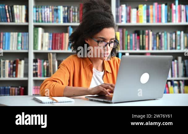 Upset shocked african american student girl, wearing glasses, sits at a ...