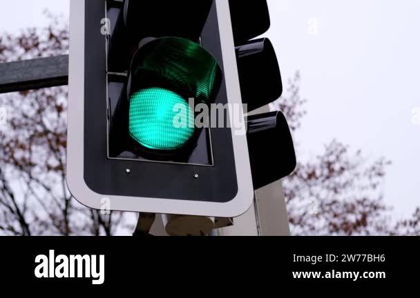 close-up street traffic light, green light turns to yellow, concept of ...