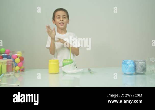 A boy was joyfully mixing a new color.Boy mixing colors Learning ...