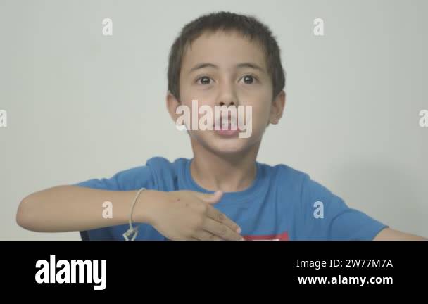 The cute boy wearing a blue shirt tasted the milk to know the taste and ...