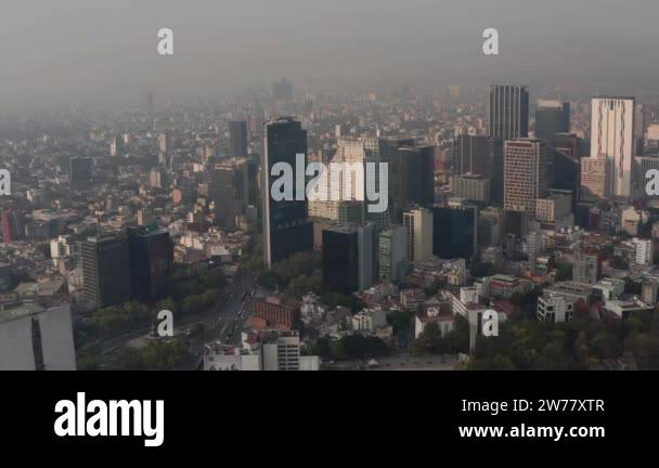 Elevated panning view of tall office building in downtown. Limited ...