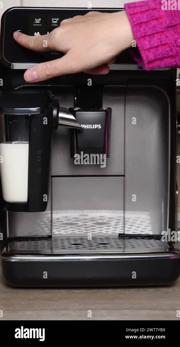 Female finger press button to switch on of fully automatic espresso ...