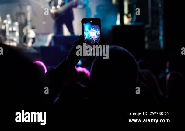 People Filming Rock Concert on Smartphones, Silhouettes Crowd of Fans ...
