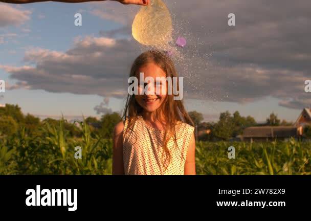 Water Balloon Splash on Little Head of a Girl Stock Video Footage - Alamy