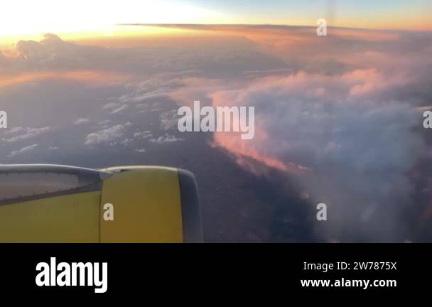 Airplane flight. Wing of an airplane flying above the clouds and sea in ...