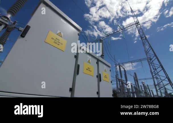 Capacitor banks with warning signs by towers at substation Stock Video ...