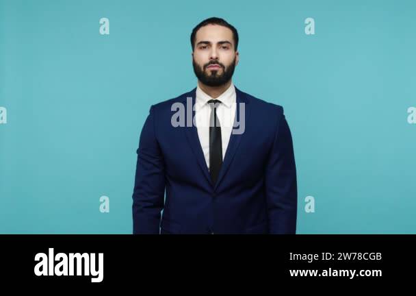 Bearded man in official style suit saluting with hand, saying yes sir ...