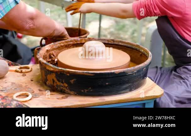 Woman and girl making ceramic pot in pottery workshop. Female hands on ...