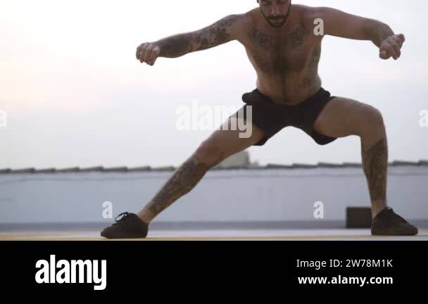 Male Practices Stretching His Legs From Left To Right As He Stretches