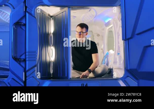 A man opens a door of a capsule hotel room from inside Stock Video ...