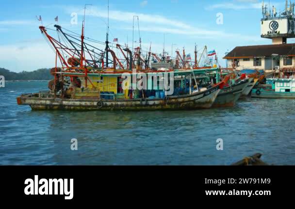 Traditional. wooden fishing boats tied together at a pier in Borneo ...