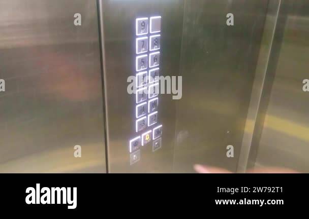 An African man's hand pressing the doors open button in an elevator ...