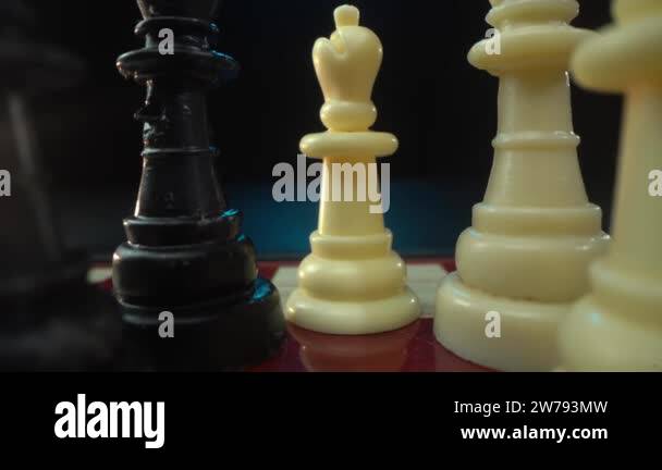 Game of chess. Filmed in a dark key. White moves with a pawn. Super ...