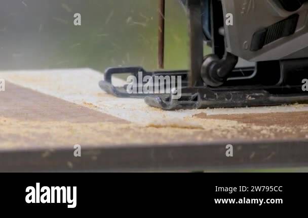 Carpentry tools. Close up of electric jigsaw in action. Manufacturing ...