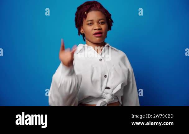Serious afro woman pointing on camera, accusing you of something, blue ...