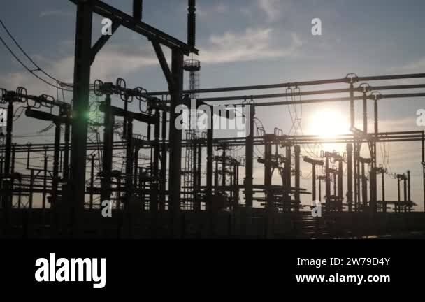 Electric power station with high metallic supports at grey and golden ...