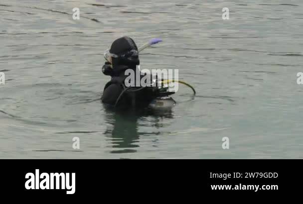 One Diver is Standing up to His Neck in Water Starts to Swim Divers in ...