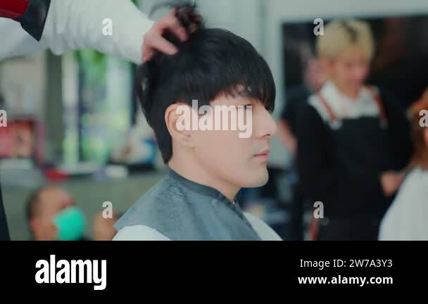 Slow motion camera movement. After the professional barber cut the hair ...