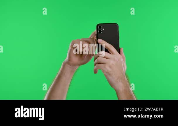 Male hands hold a smartphone vertically against the background of a ...