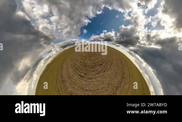little planet revolves among beautiful blue sky with rain clouds. tiny ...