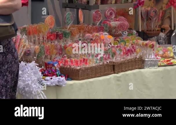colorful sweets sold in city street fair and people with children. 4K ...