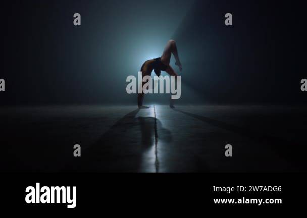 Flexible gymnast doing backbend exercises. Beautiful woman stretching ...