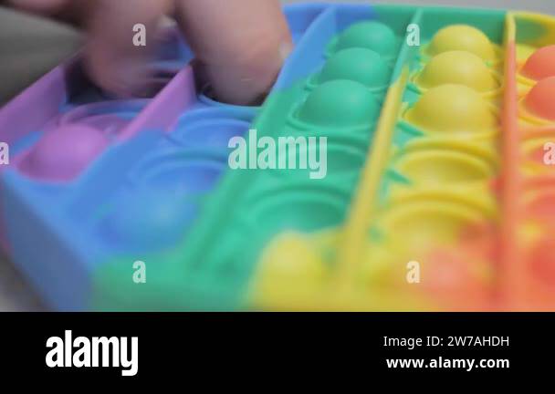 clicks on the toy Pop It Fidget. side view Stock Video Footage - Alamy