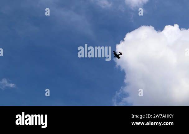 Ultralight small propeller-driven private jet flying in the sky with ...