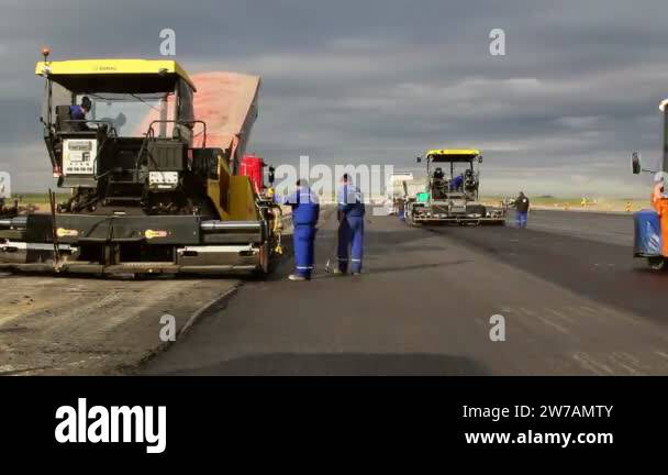 Tracked paver laying fresh asphalt pavement,time lapse Stock Video ...