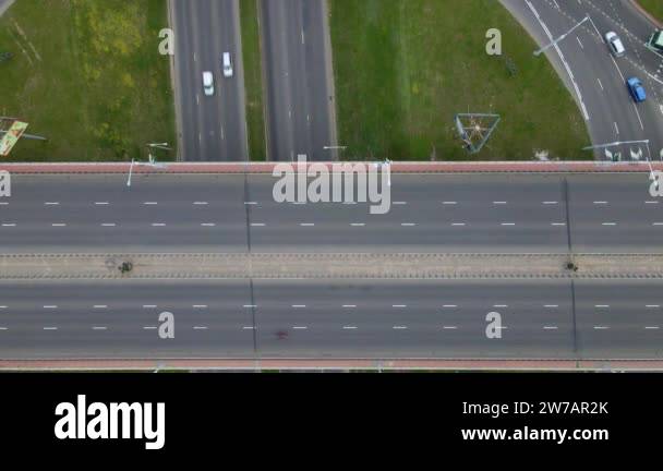 Flight over city roads. Above a multilevel road junction, the camera is ...