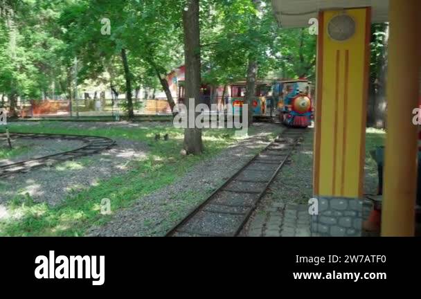 Mom and children ride a small steam locomotive. Family fun in the ...