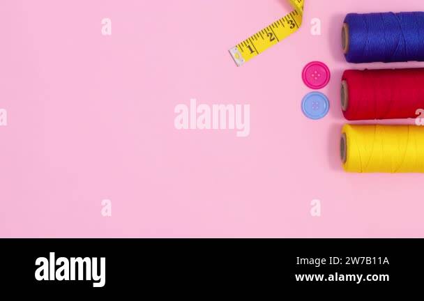 Sewing and knitting items appear on right side of pastel pink ...