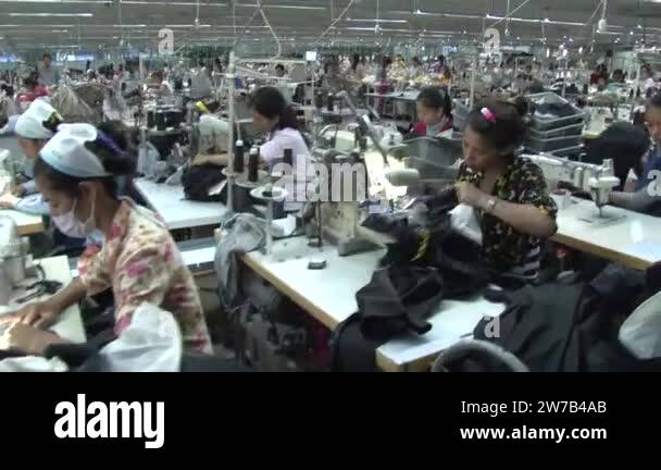 Textile Garment Factory Workers: Dolly type move along aisles of ...